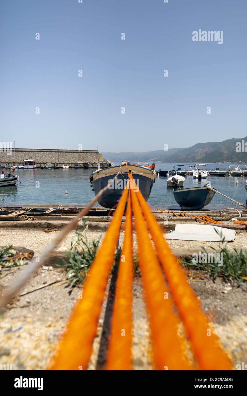 Leading lines of orange ropes moring a boat Stock Photo - Alamy