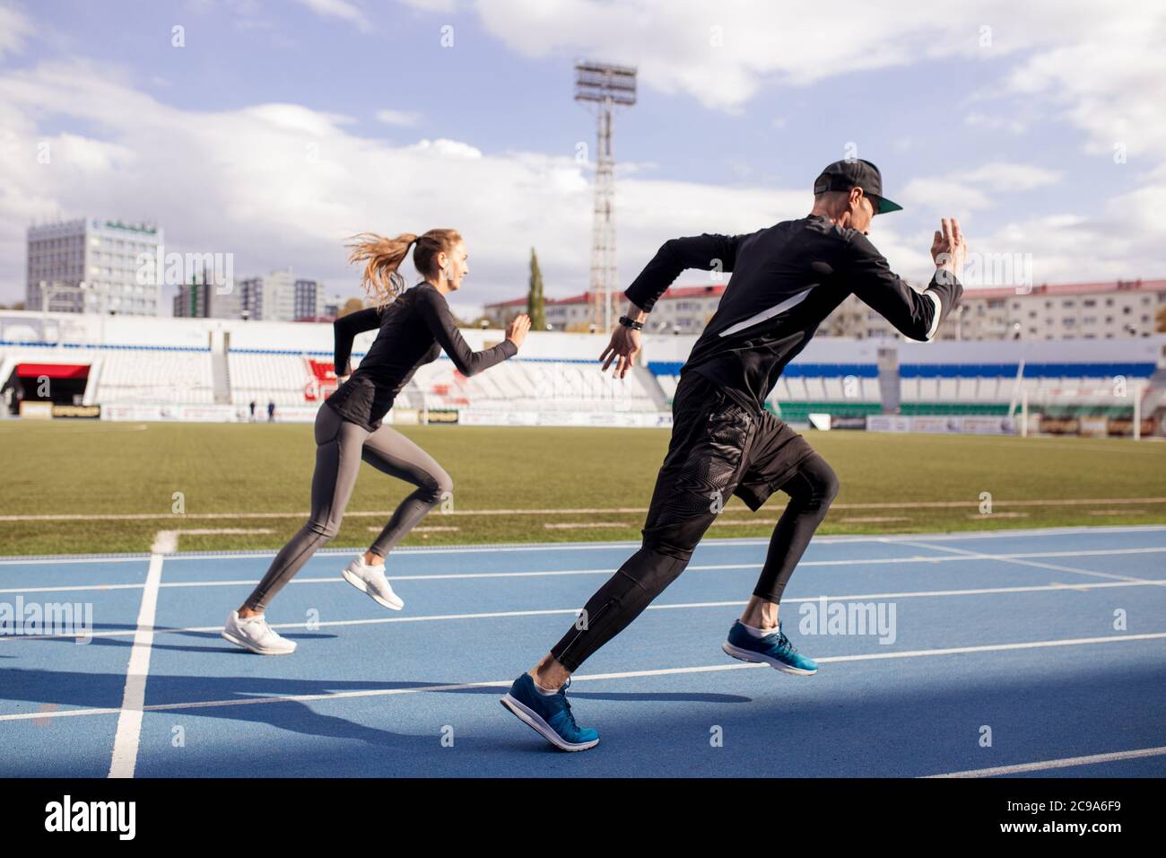 full length side view shot. sprinting man and woman in the arena. speed ...