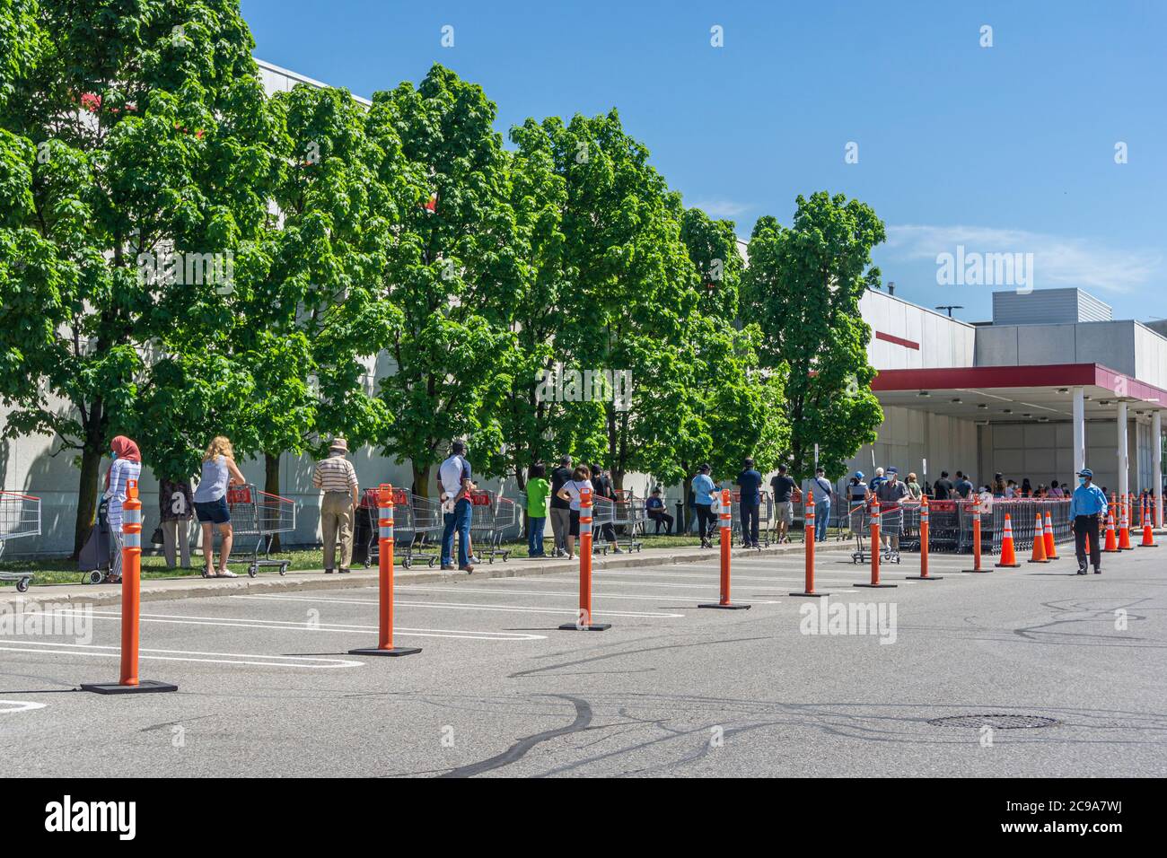 Toronto, Canada, June 2020 - Customers line up by a grocery store ...