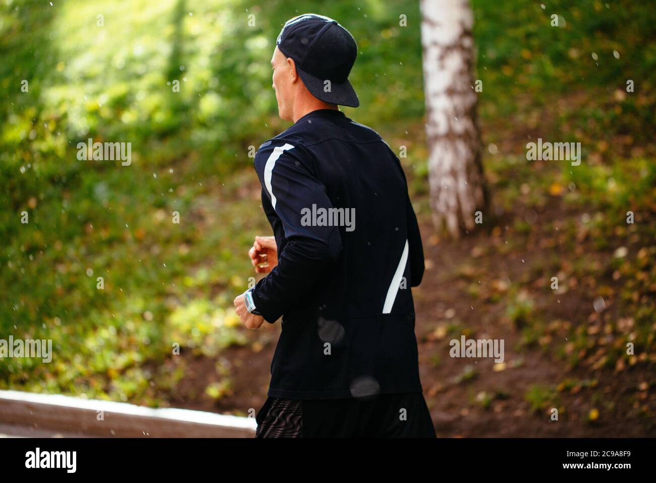active hardworking runner doing his best. back view shot. sporty life ...