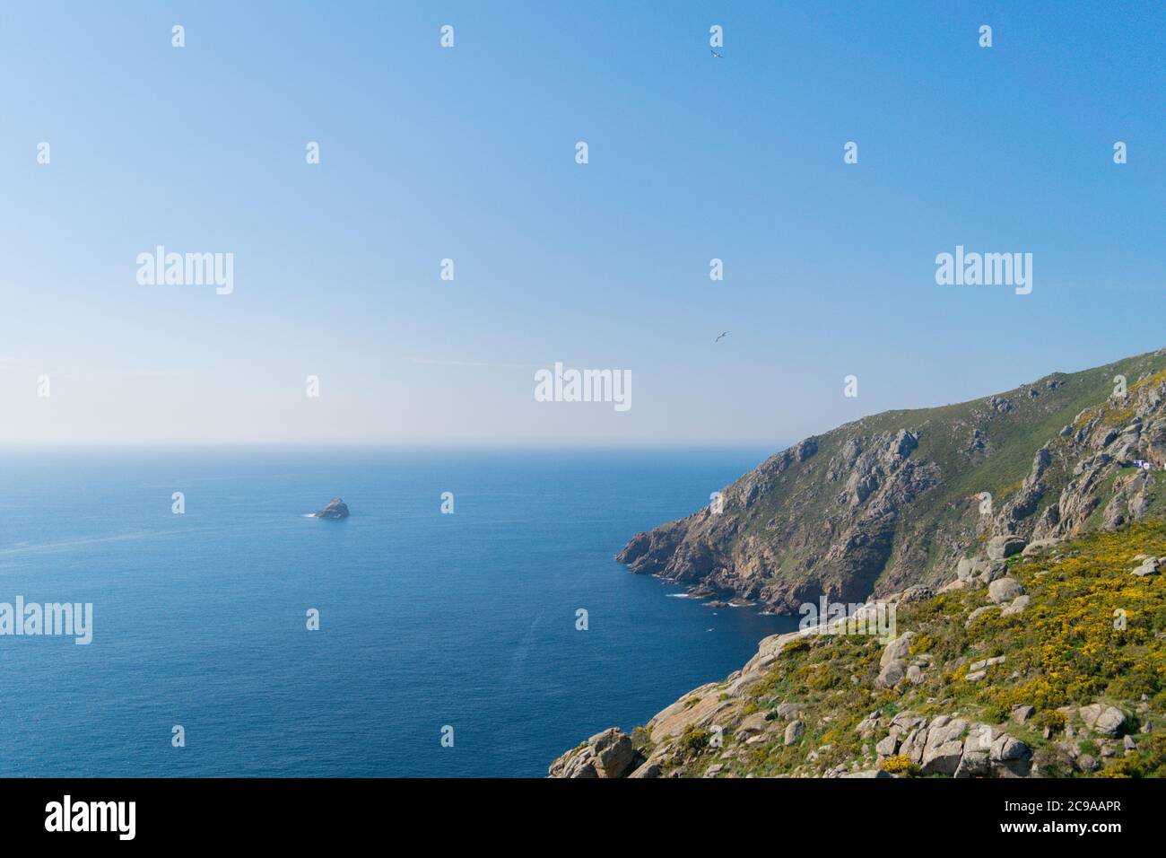 Beautiful view of Cape Finisterre in Fisterra, Spain with a blue sky ...