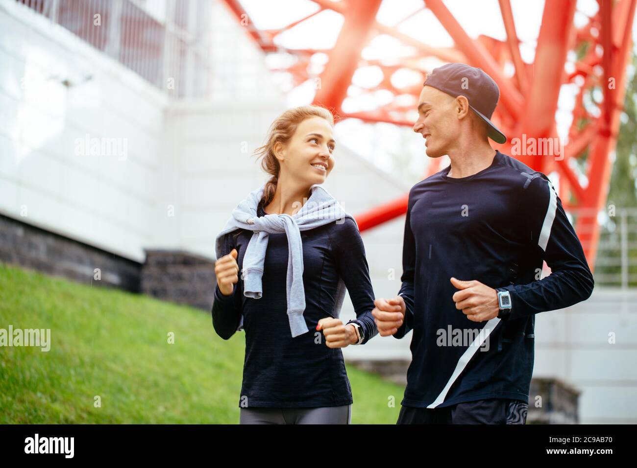lifestyle. health concept. two runners enjoying time together. side ...
