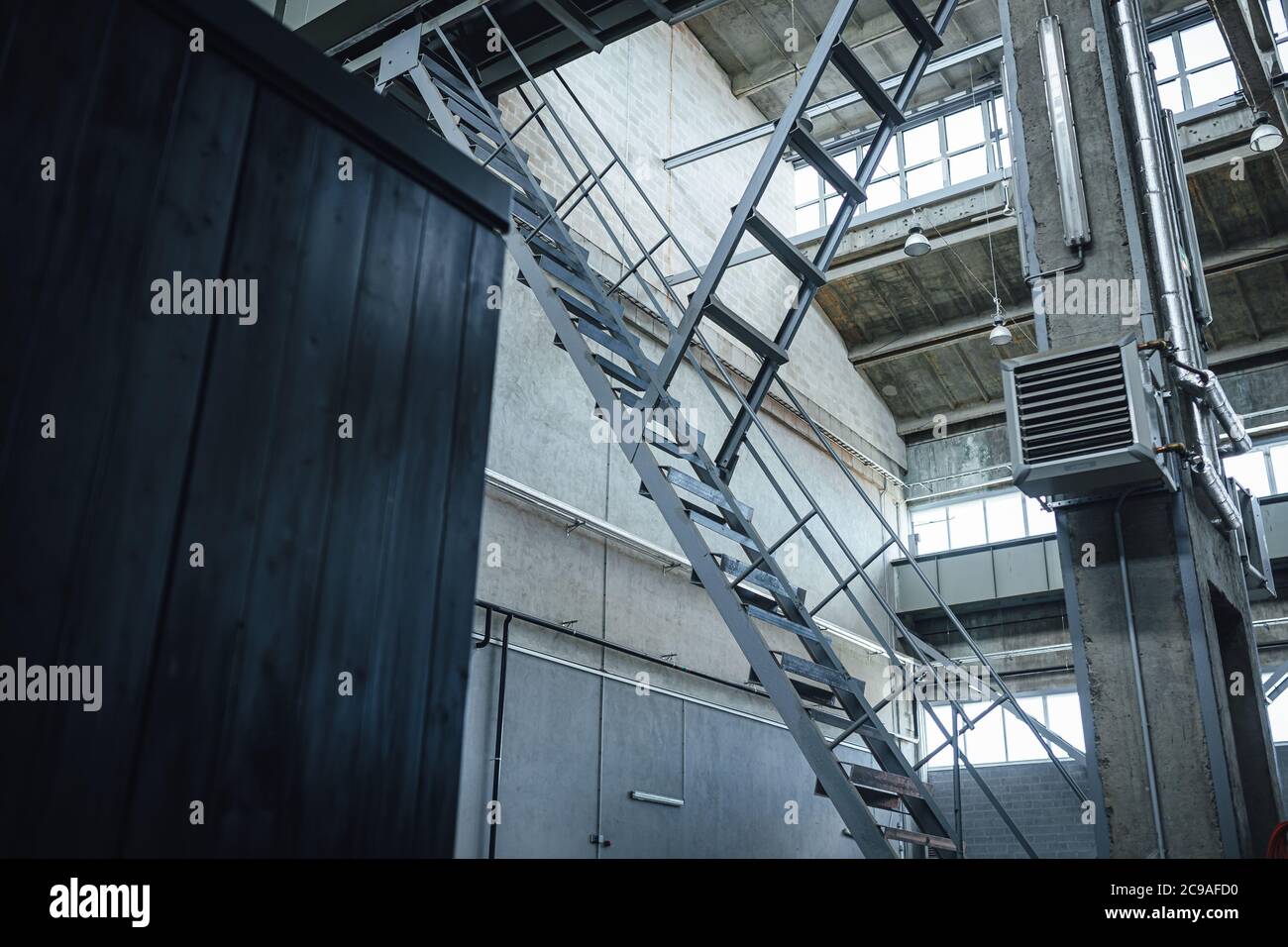 Low angle shot inside a huge factory Stock Photo - Alamy