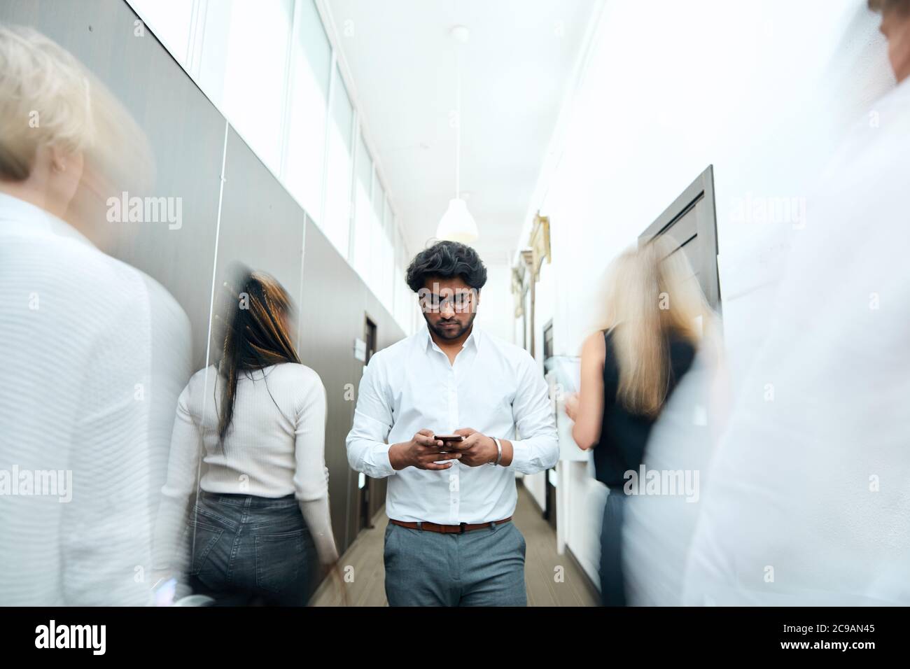 handsome man is concentrated on chatting with friend while office ...