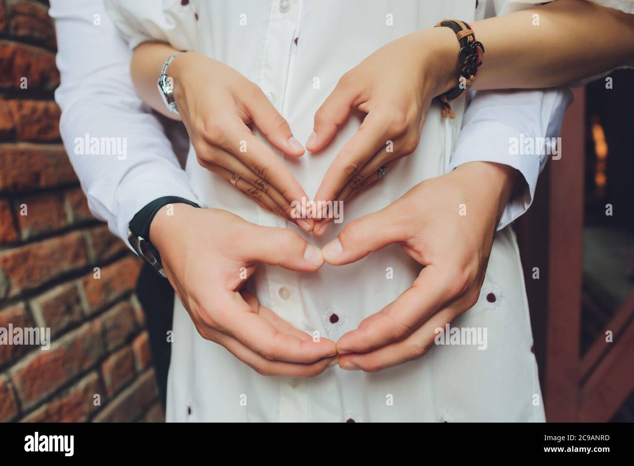 Closeup of couple making heart shape with hands Stock Photo - Alamy