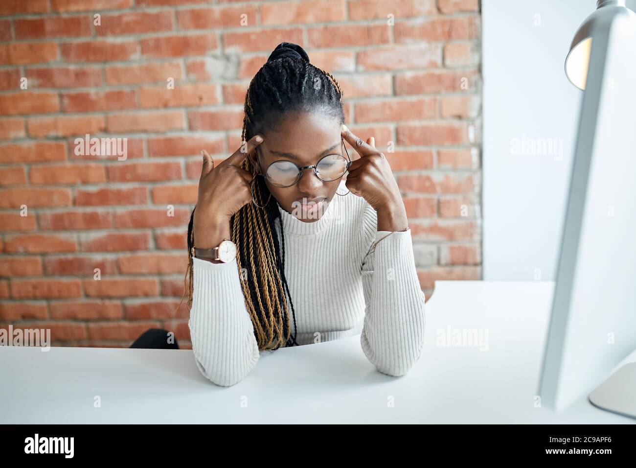 tired Afro office worker having headache. freelancer trying to remember ...