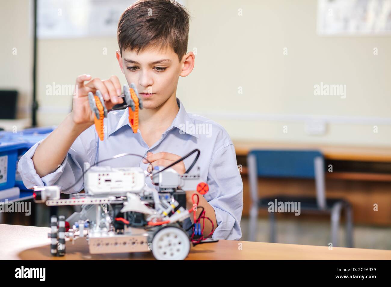 Little boy in robotics school makes robot managed from the constructor ...