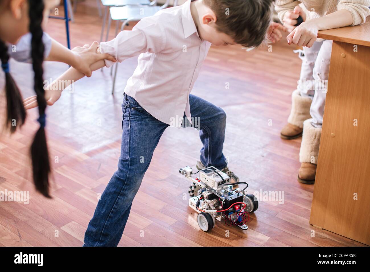 Learning process in robotics school. Curious kid playing with self made ...