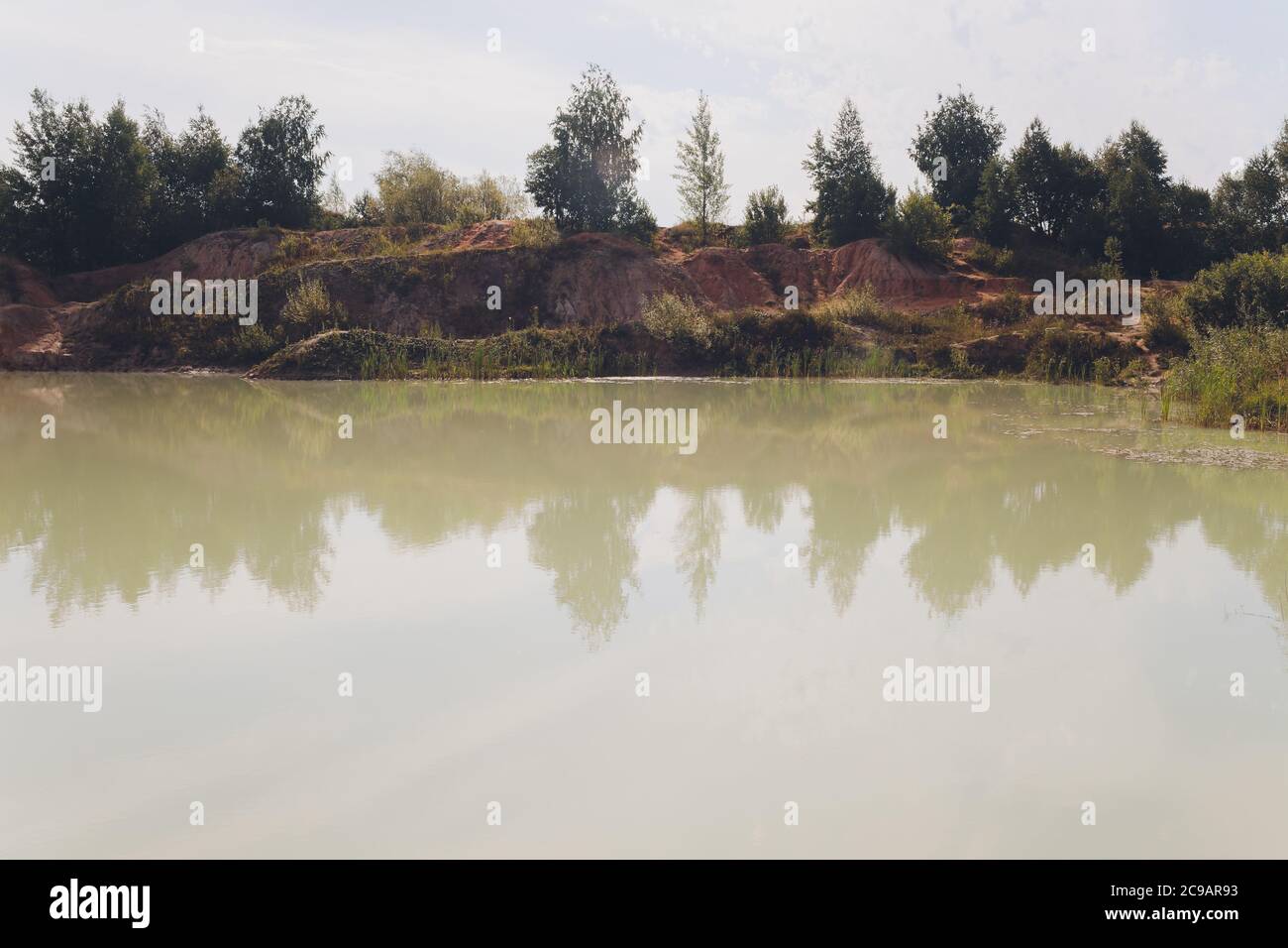 Open pit asbestos quarry lake with blue water Stock Photo - Alamy