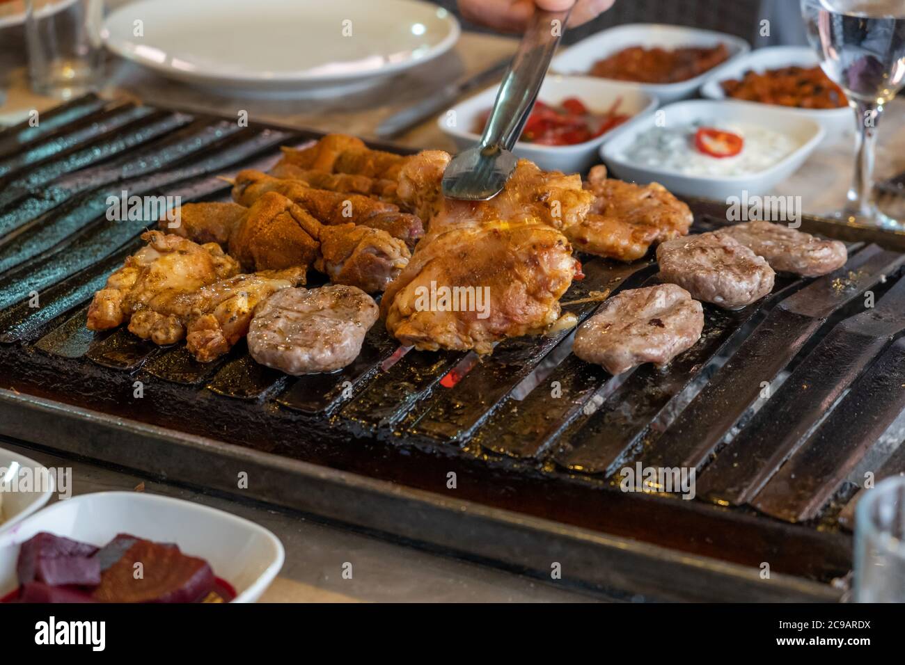 Different types of meat grilled on Barbecue on the table, Served with ...