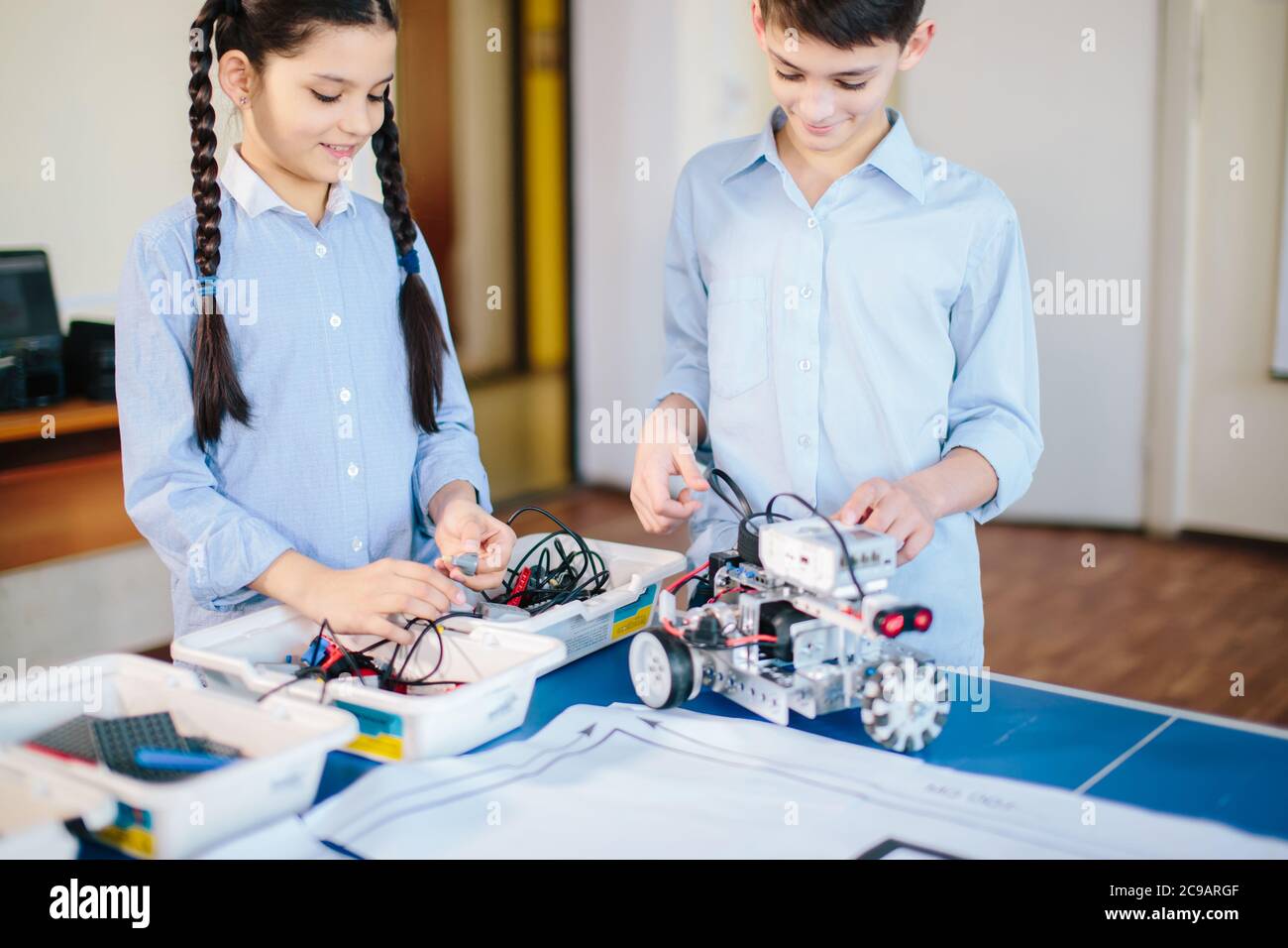 Two teenage caucasian kids, curious smart brother with sister, enaging ...