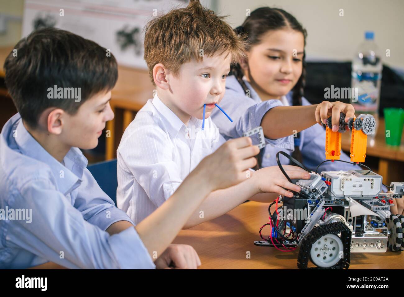 Happy little inventor kids fit the separate component parts of ...