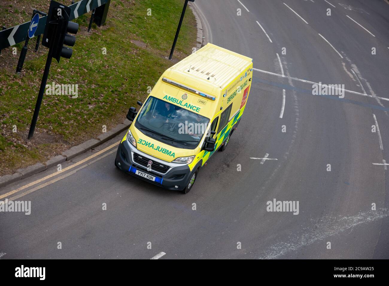 Overhead shot of an ambulance driving on an urban dual carriageway ...