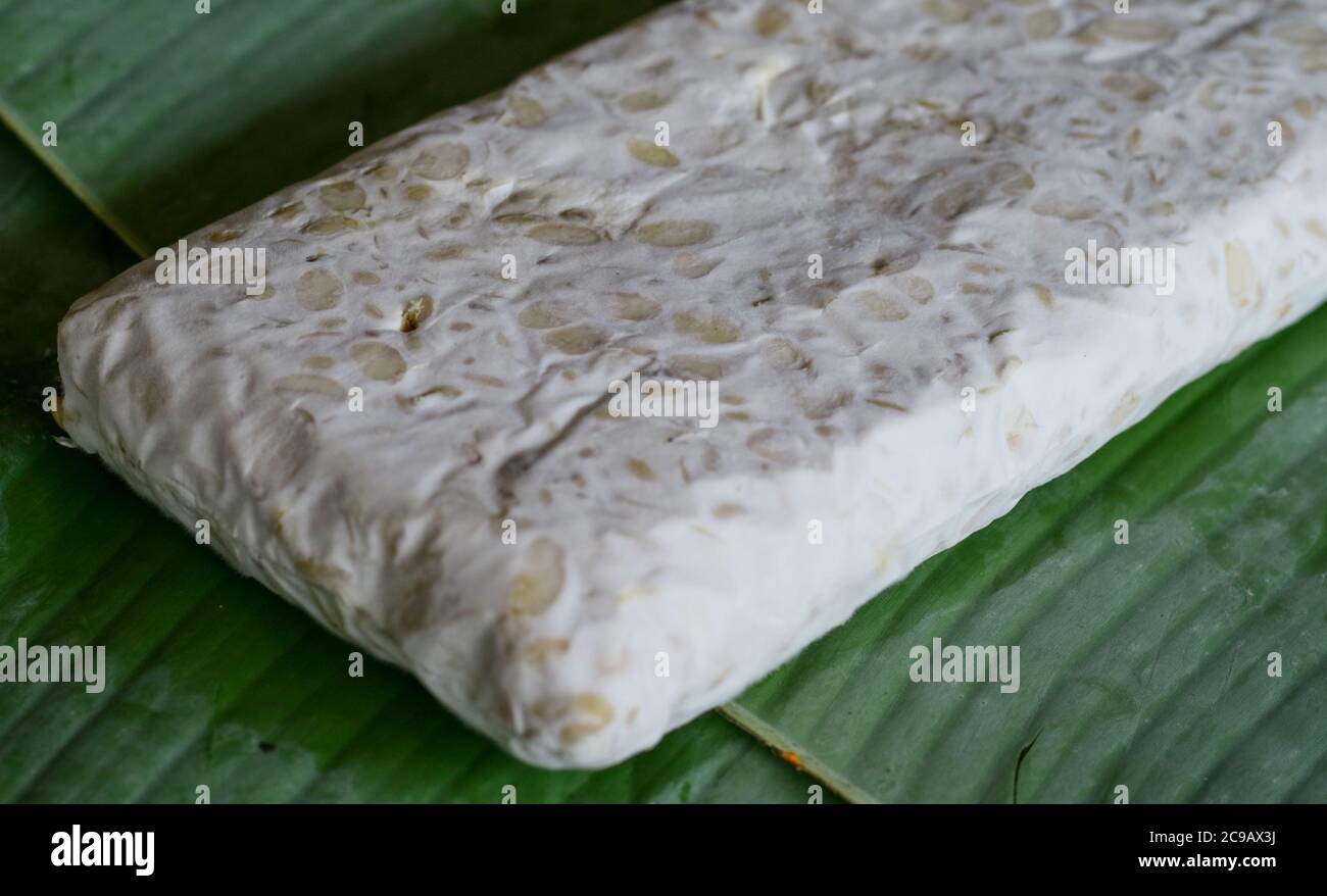 Raw tempeh on banana leaf. Tempeh is a traditional soy product ...