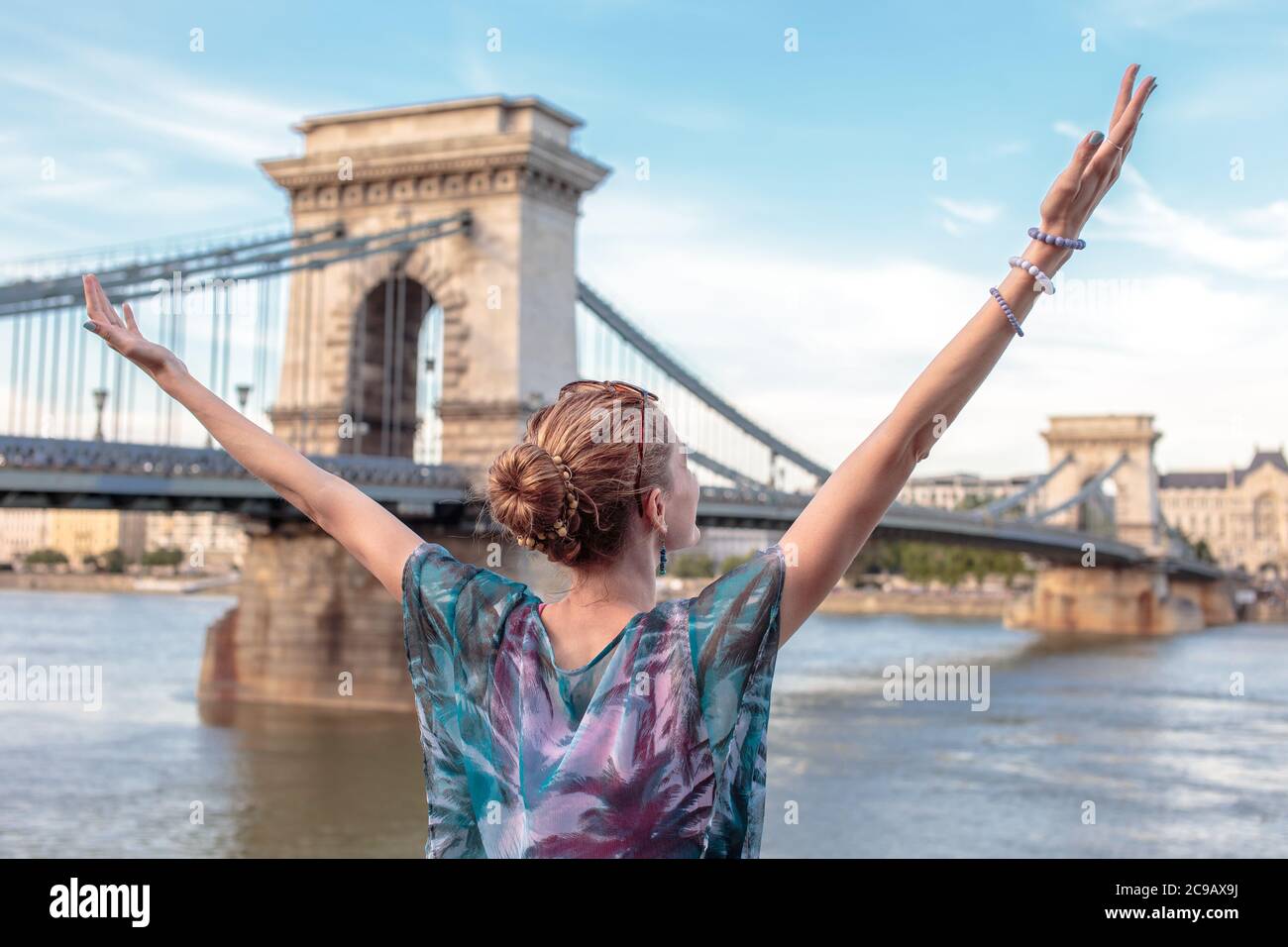 Rear view of woman with raised arms hi-res stock photography and images ...