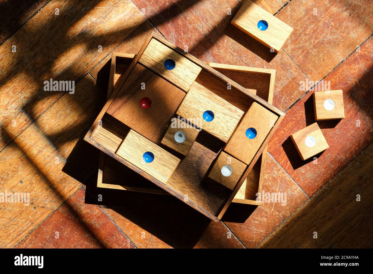 Wooden tray puzzle sitting in a patch of sunlight on a worn wooden ...