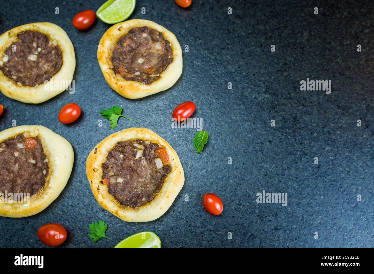 Delicious Lebanese (Arabic) food, legitimate sfihas on a black granite ...