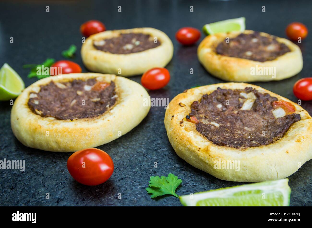 Delicious Lebanese (Arabic) food, legitimate sfihas on a black granite ...