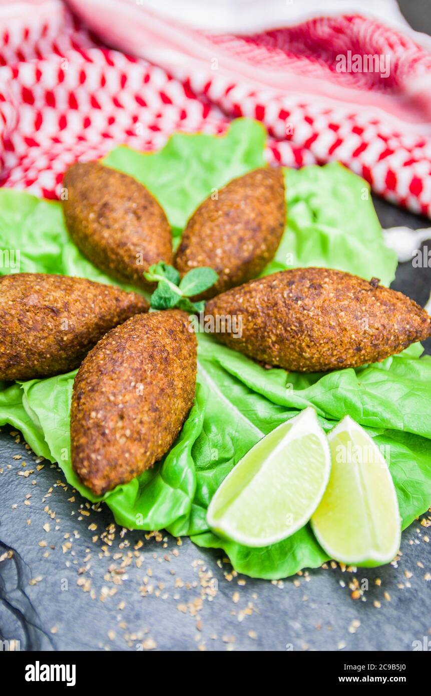 Delicious Lebanese (Arabic) food, kibbeh (kibe) with sauces and lemon ...