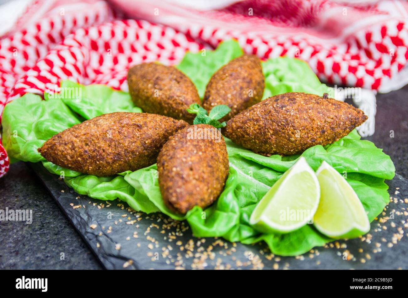 Delicious Lebanese (Arabic) food, kibbeh (kibe) with sauces and lemon ...