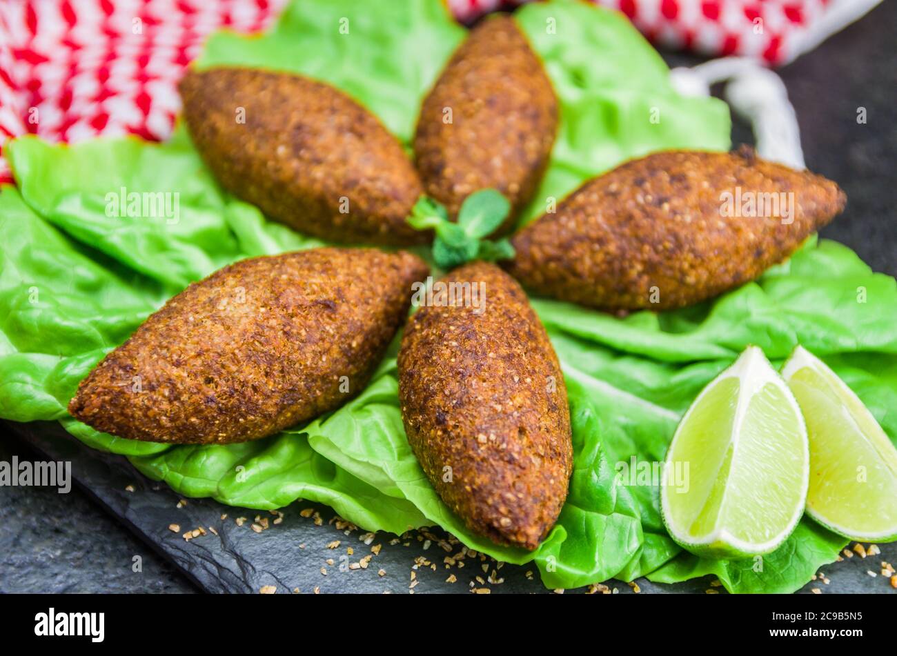 Delicious Lebanese (Arabic) food, kibbeh (kibe) with sauces and lemon ...