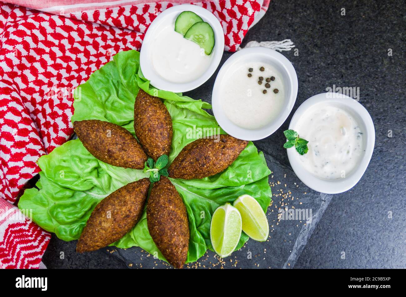 Delicious Lebanese (Arabic) food, kibbeh (kibe) with sauces and lemon ...