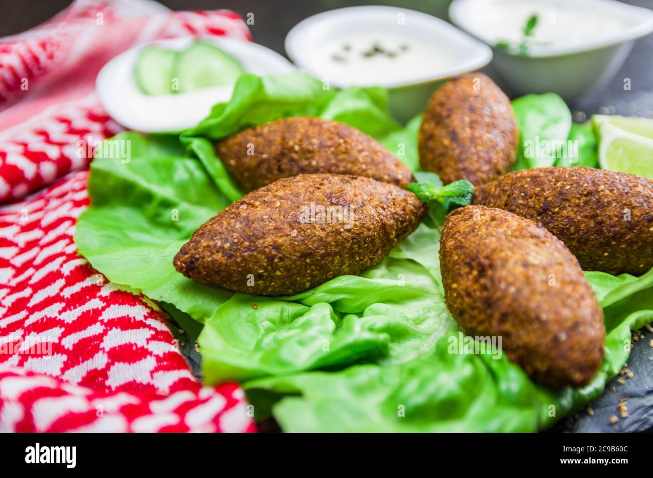 Delicious Lebanese (Arabic) food, kibbeh (kibe) with sauces and lemon ...