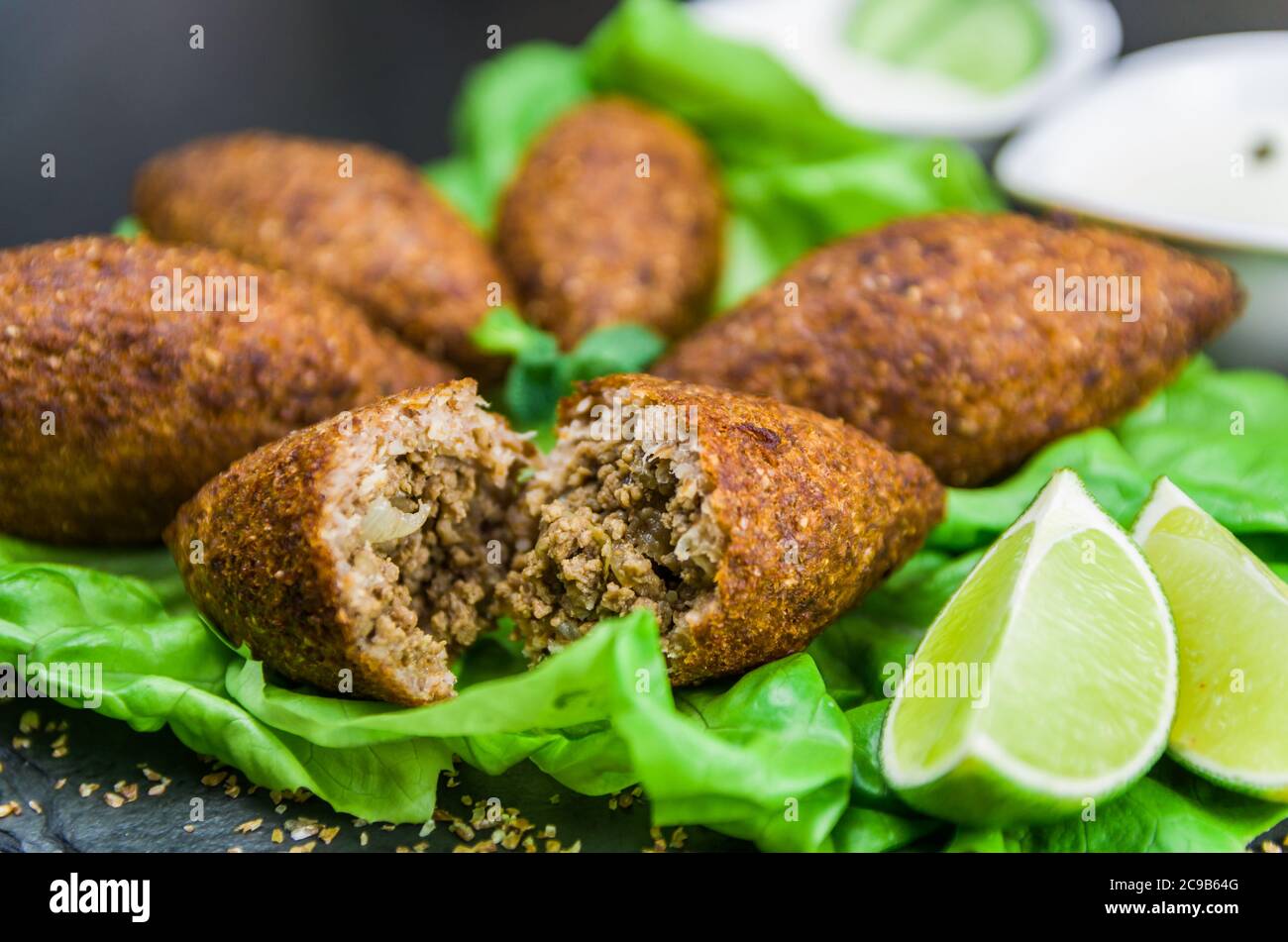 Delicious Lebanese (Arabic) food, kibbeh (kibe) on black slate stone ...