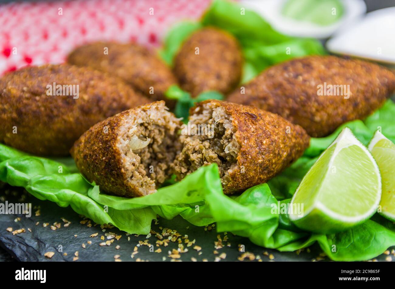 Delicious Lebanese (Arabic) food, kibbeh (kibe) with sauces and lemon ...