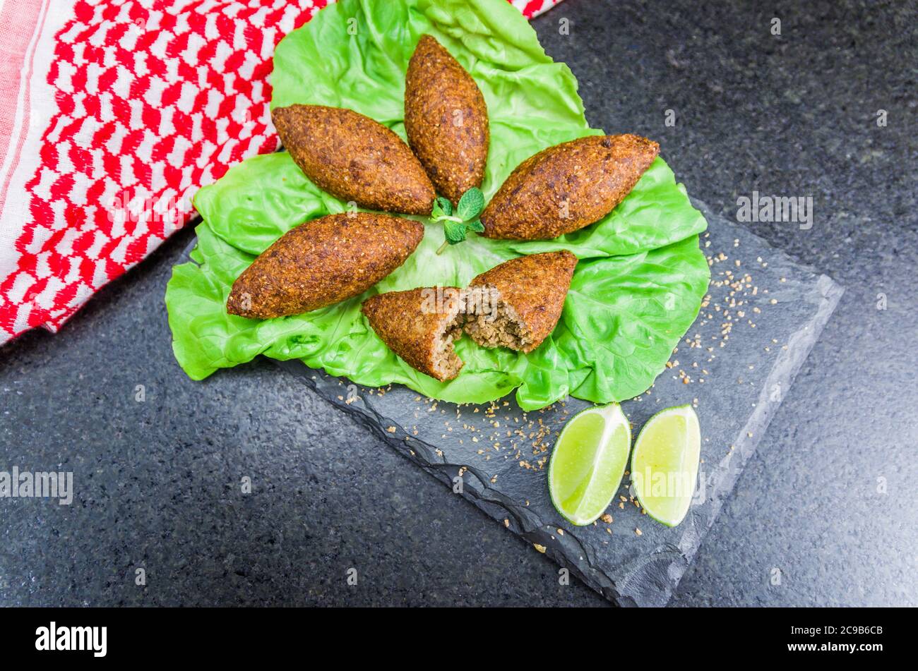 Delicious Lebanese (Arabic) food, kibbeh (kibe) with sauces and lemon ...