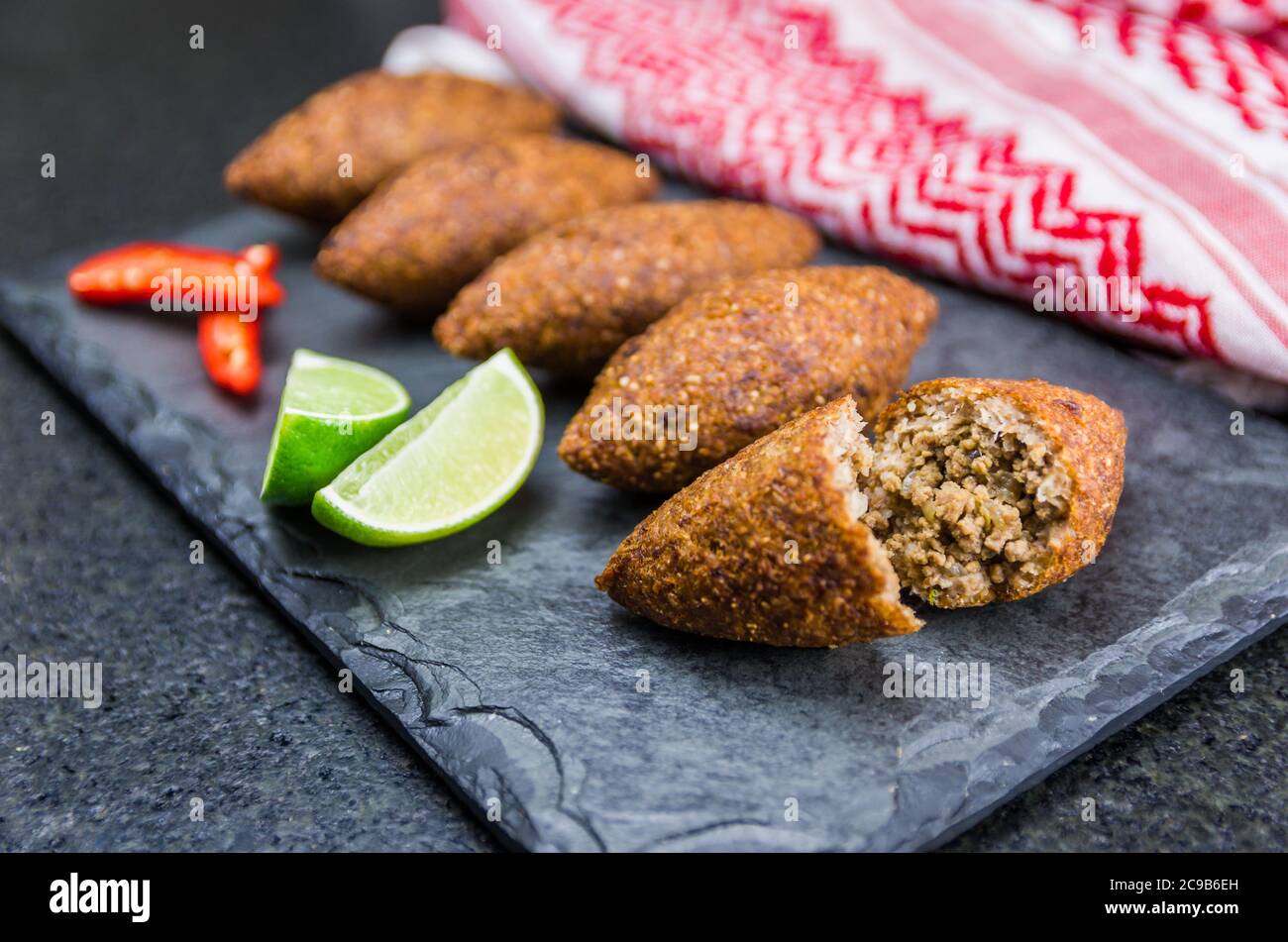Delicious Lebanese (Arabic) food, kibbeh (kibe) with sauces and lemon ...