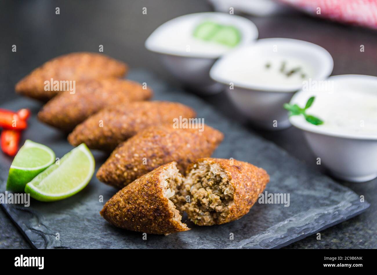 Delicious Lebanese (Arabic) food, kibbeh (kibe) on black slate stone ...