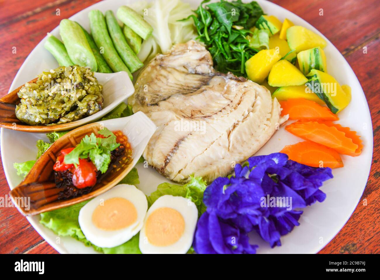 Steamed fish with chili sauce boiled eggs and vegetables pumpkin carrot ...