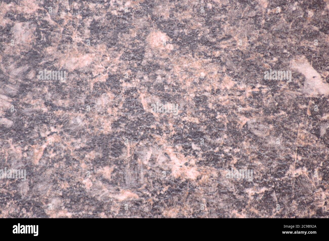 Black-red granite, polished surface of natural stone close-up ...