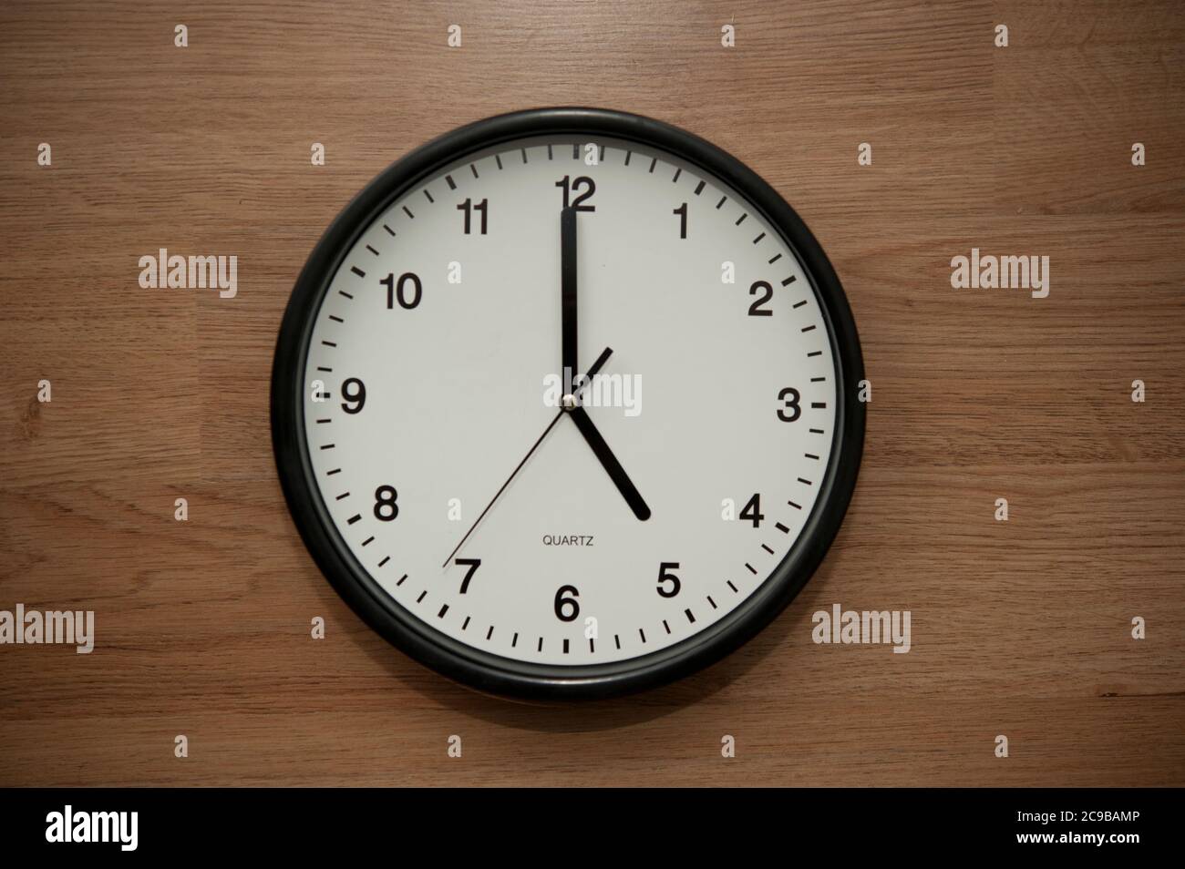 wall clock indicating the five o'clock hour Stock Photo - Alamy