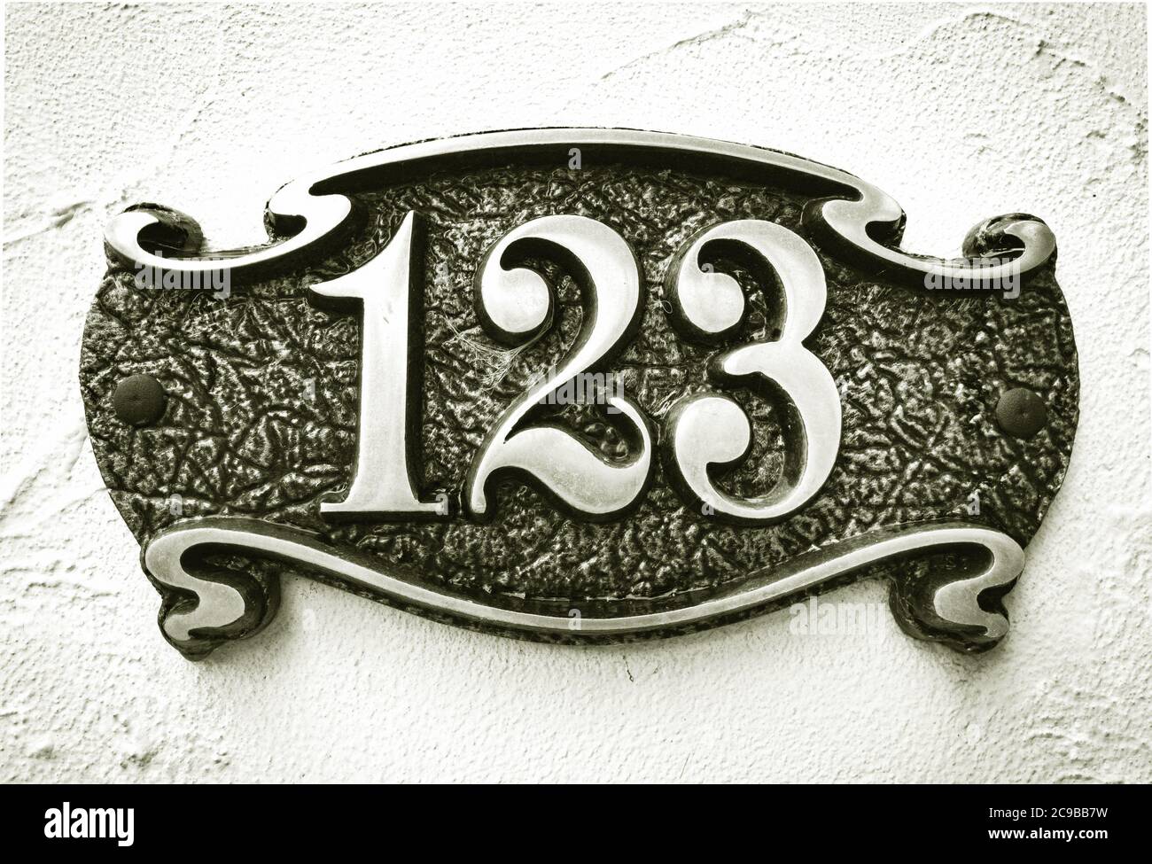 bronze house address number plate 123 Stock Photo - Alamy