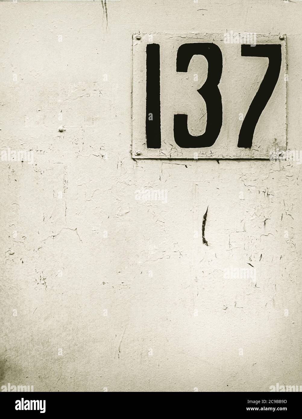 old house address number plate on white wall Stock Photo - Alamy