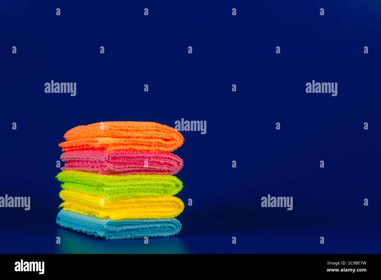 different color rags on a blue background Stock Photo - Alamy