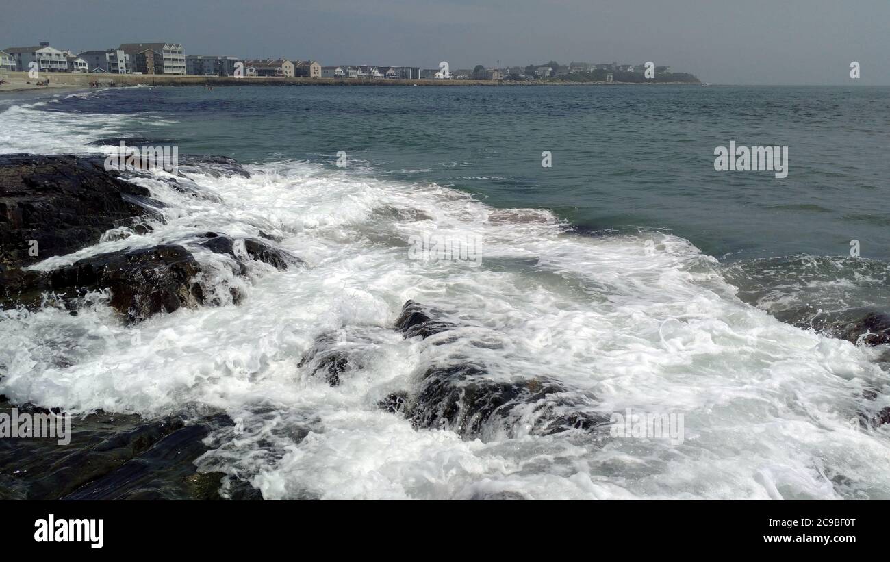 Surf waves running in the coastal rocks at the beach Stock Photo - Alamy