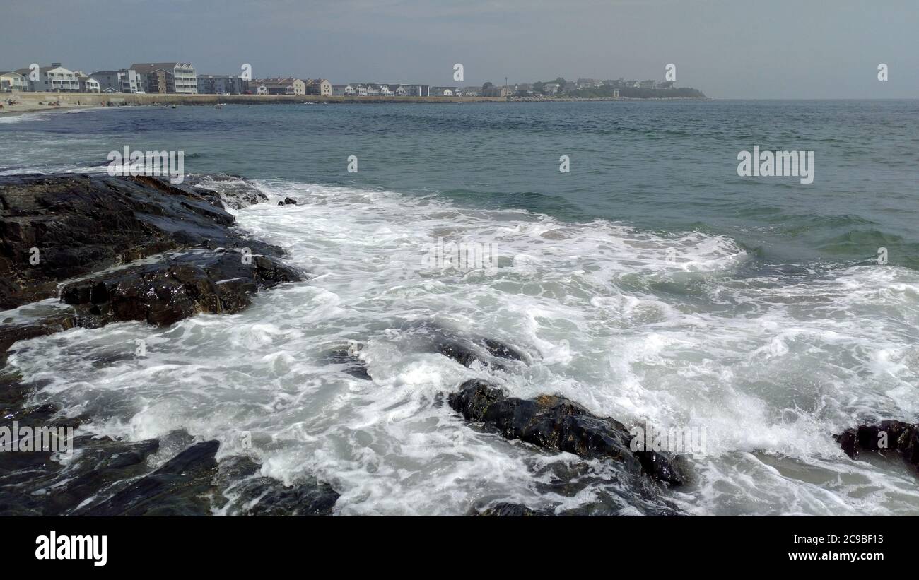 Surf waves running in the coastal rocks at the beach Stock Photo - Alamy