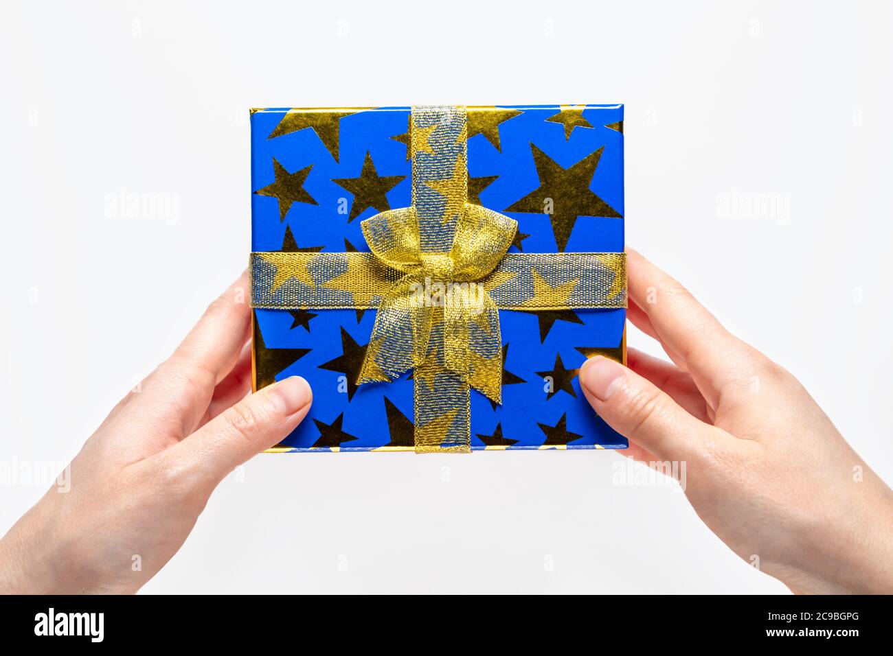 Gift or present box with golden ribbon on white background with female ...