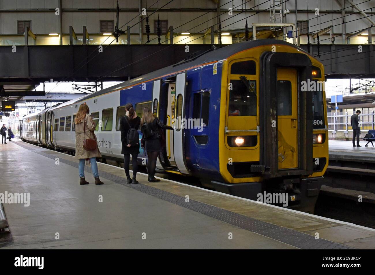 Passengers getting on a Northern Trains Class 158 Express DMU at Leeds ...