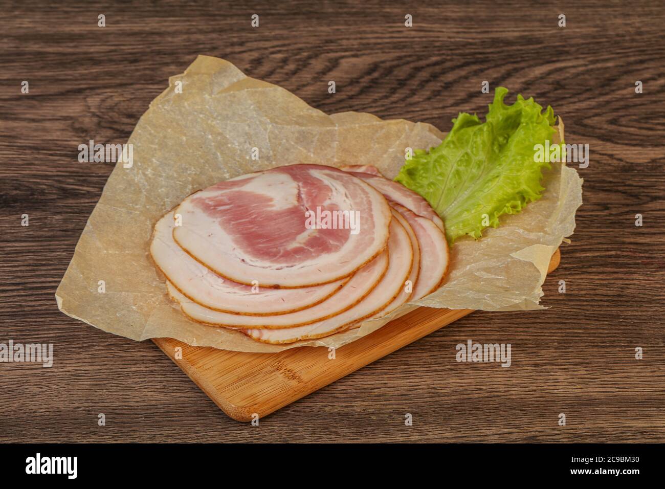 Sliced Italian Pancetta sausage over board Stock Photo - Alamy
