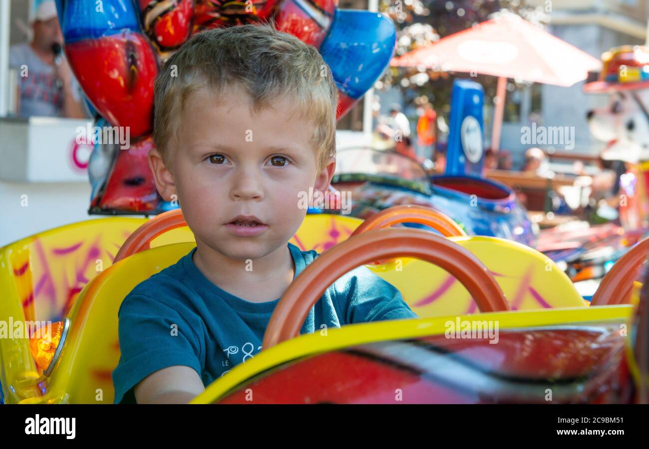 a portrait of little boy in a merry-go-round Stock Photo - Alamy