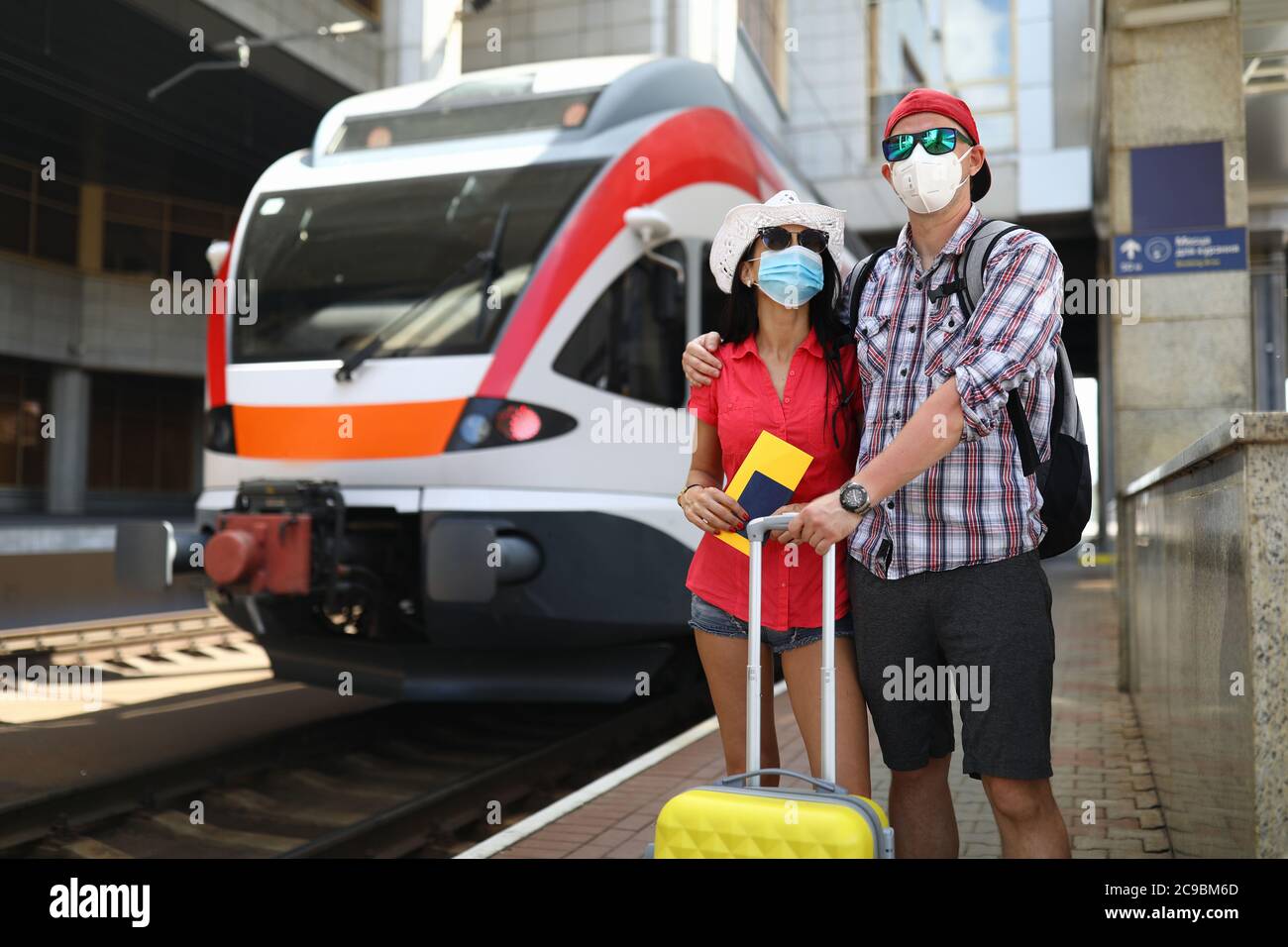 Family stands next to a train waiting for boarding Stock Photo - Alamy