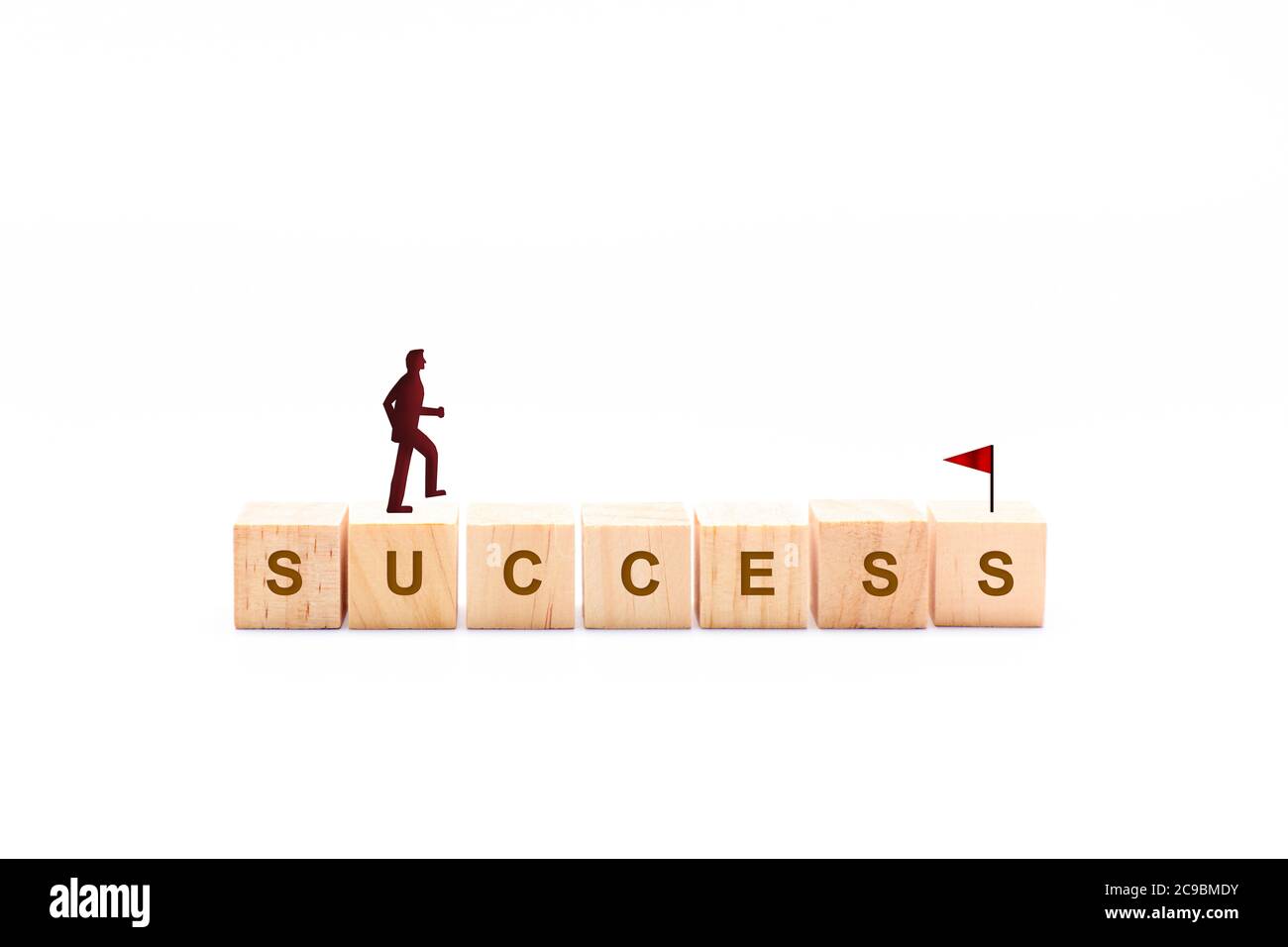 Word SUCCESS in dice and with the figure of a person advancing the goal ...