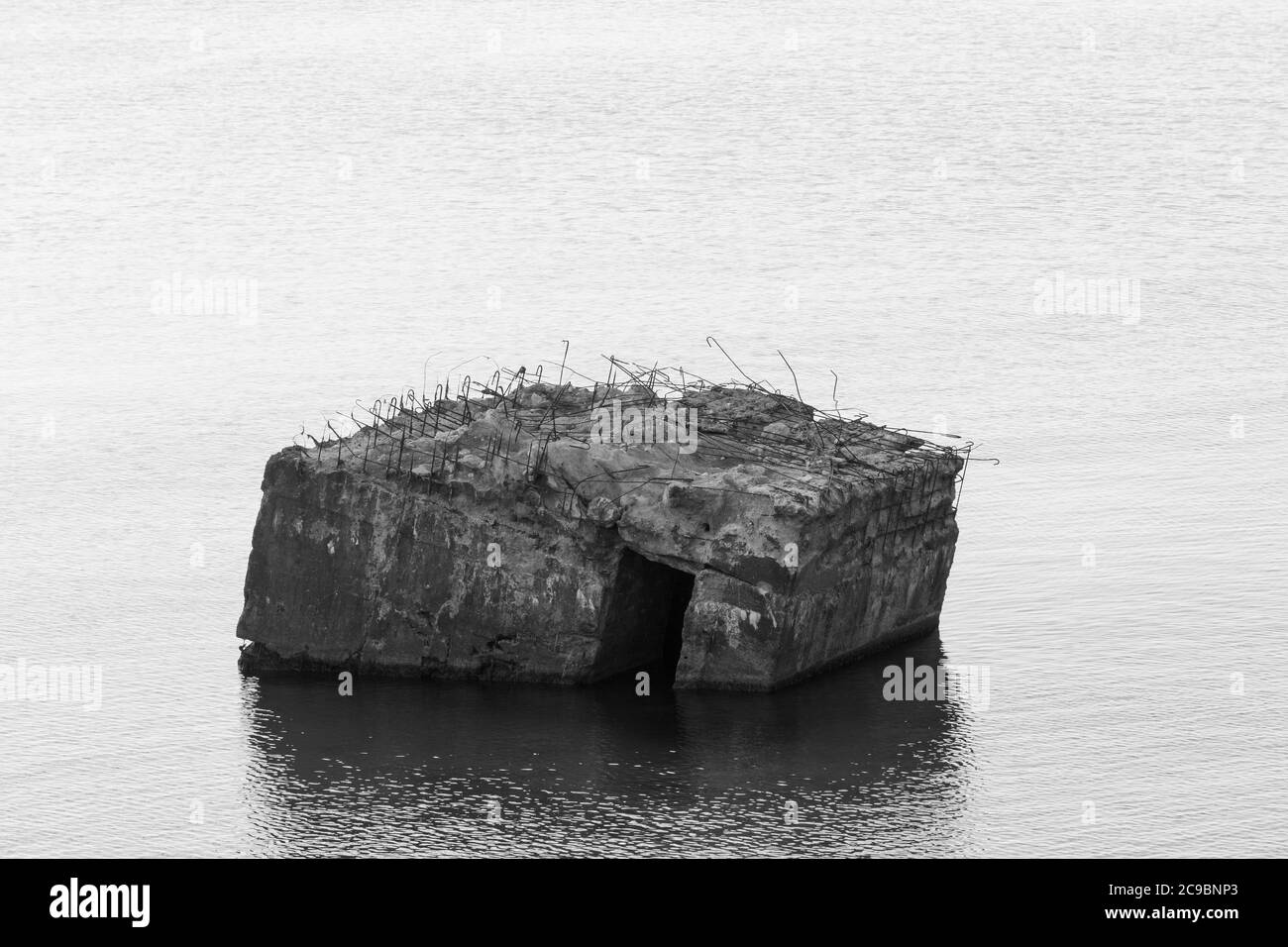 Old German bunker is rinsed out in the sea on the cliffs of the Baltic ...