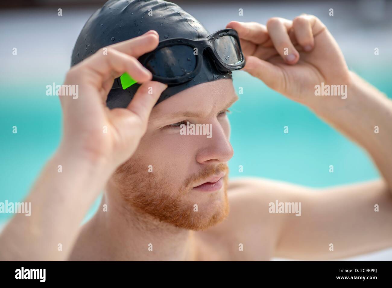 Face of bearded young man in wet swimming cap Stock Photo - Alamy