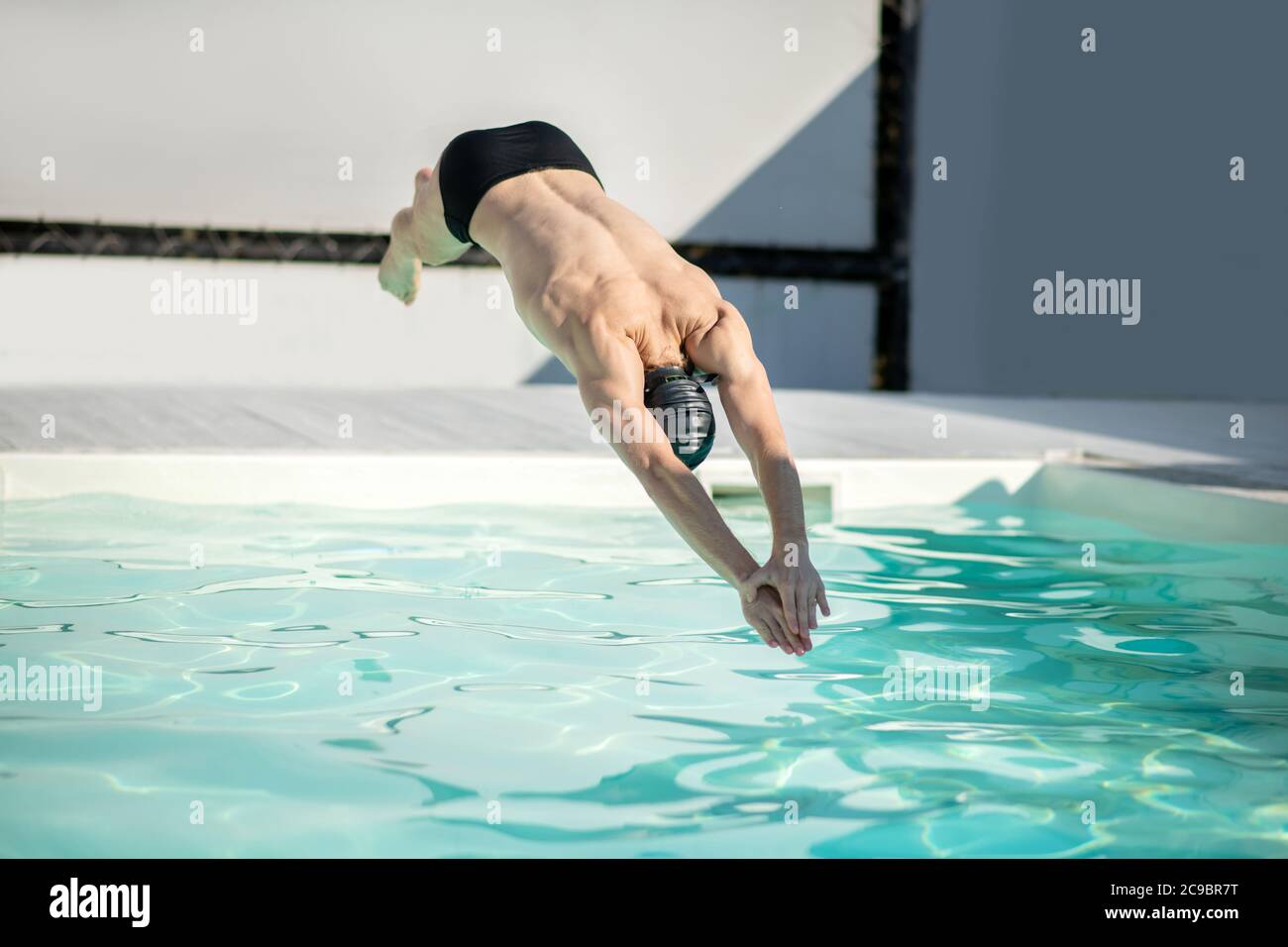 Man jumping in swimming pool hi-res stock photography and images - Alamy