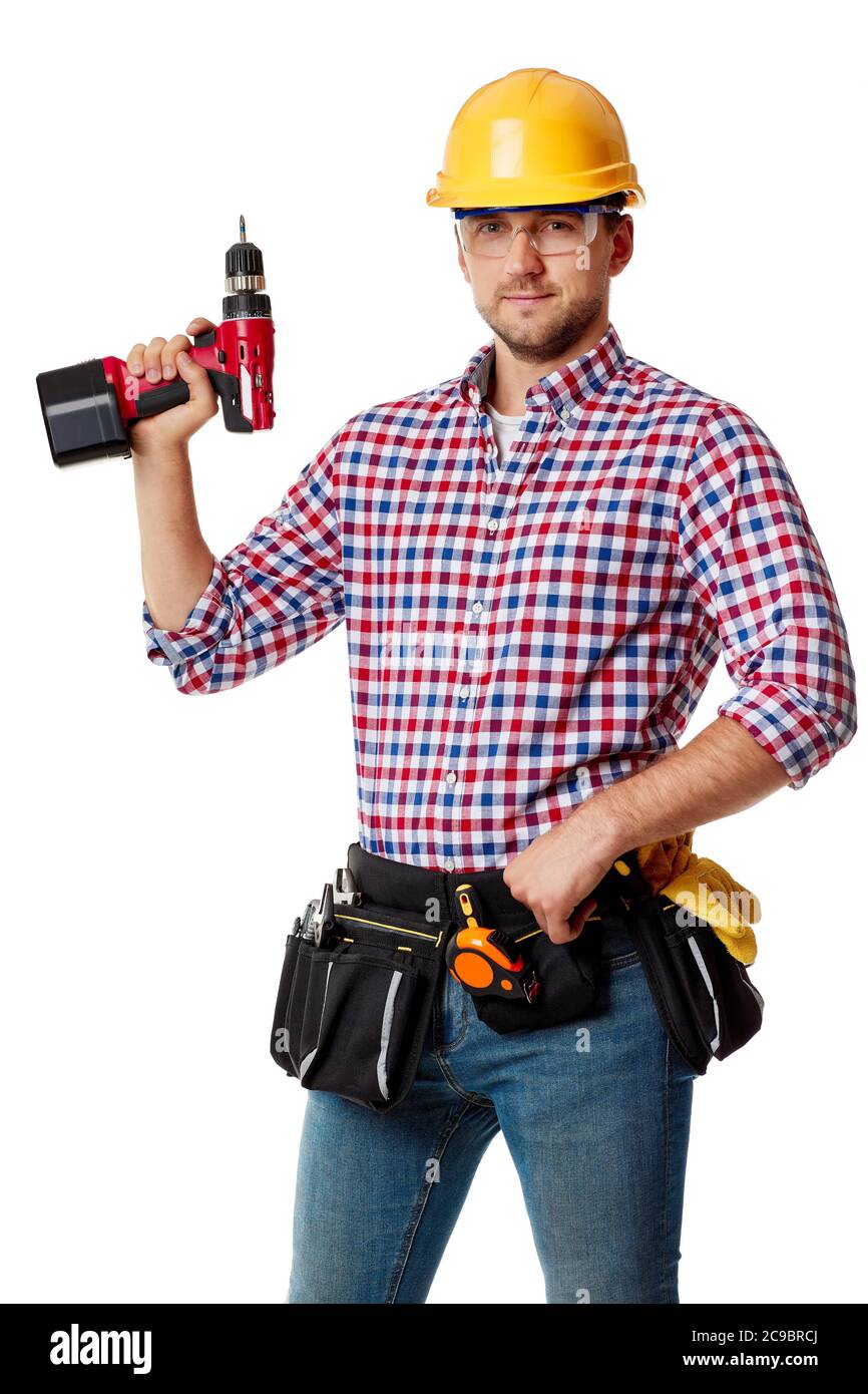 caucasian repairman worker in yellow helmet holding cordless ...